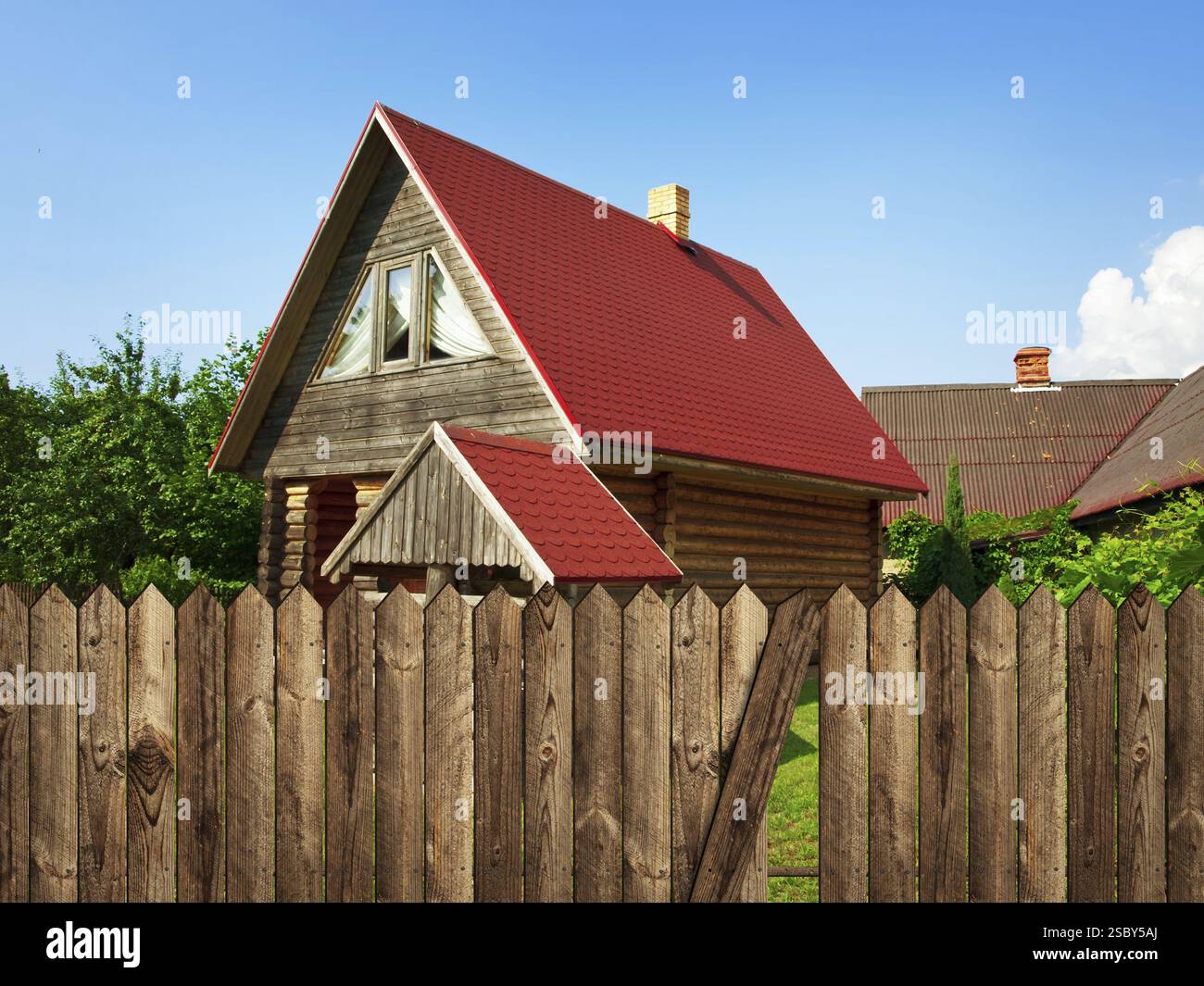 Wooden village house behind the fence Stock Photo - Alamy