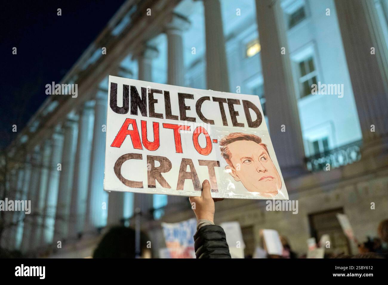 People protest during a rally against Elon Musk outside the Treasury ...
