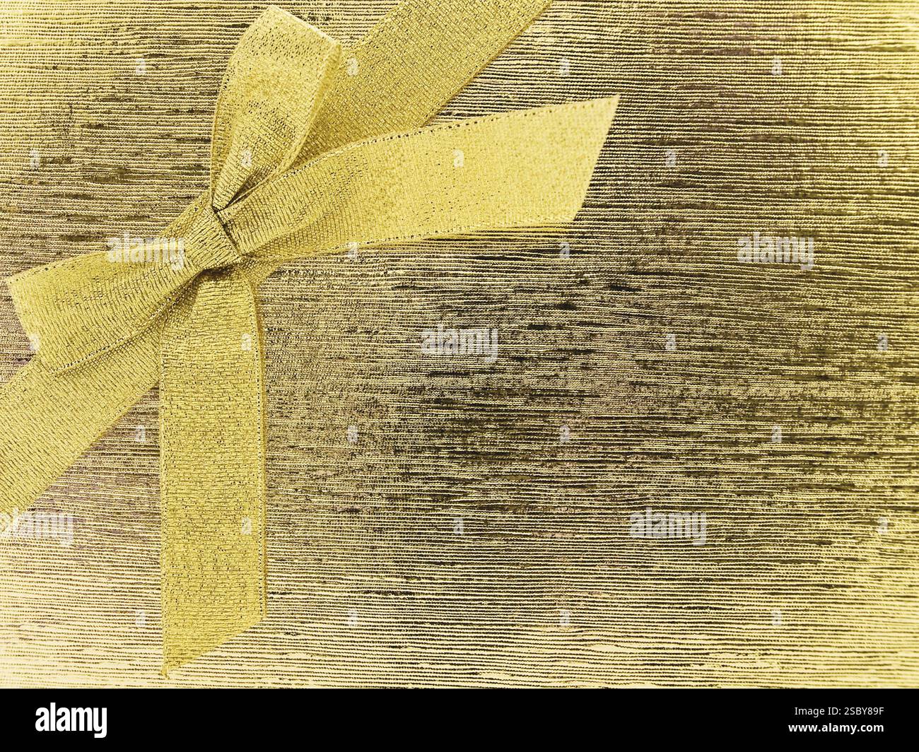 Golden bow over the abstract gold background Stock Photo - Alamy