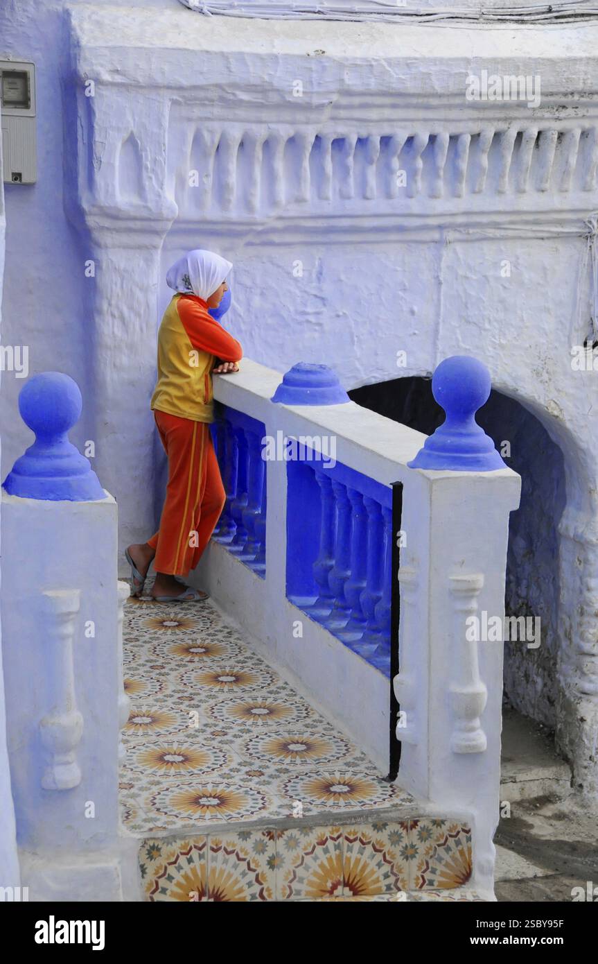 Chefchaouen, Rif Mountains, Morocco, Girl standing at a railing in a ...