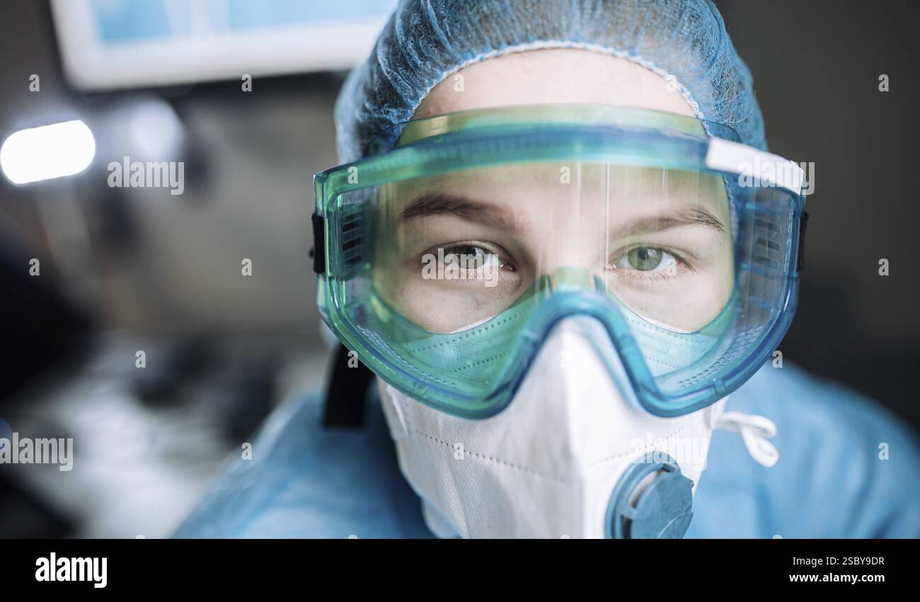 Medical personnel in complete protective attire, facial expression ...