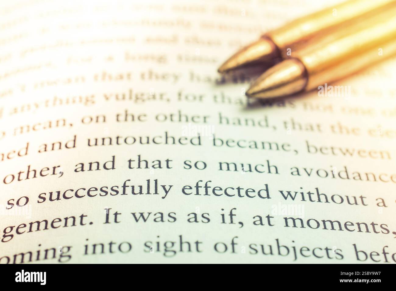 Rifle bullet model on an old book page Stock Photo - Alamy