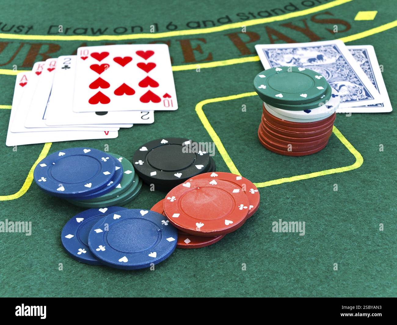Card deck and a few color chips on the playing table in the casino ...
