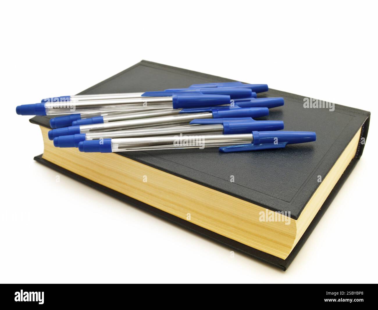 Many Pens At The Book Against The White Background Stock Photo - Alamy