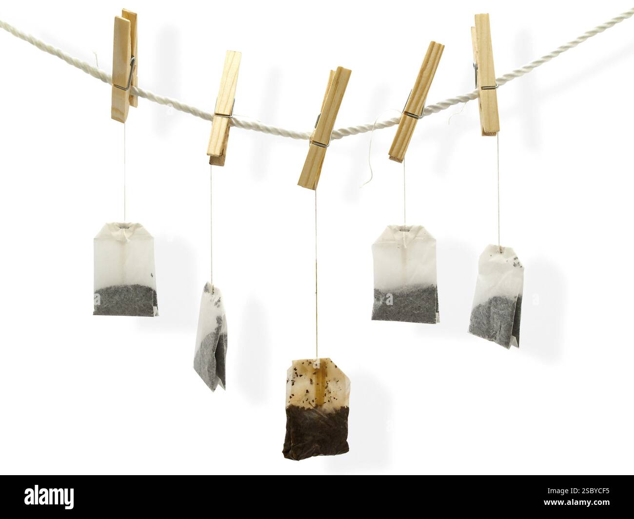 Drying tea bags at the peg against white background Stock Photo - Alamy