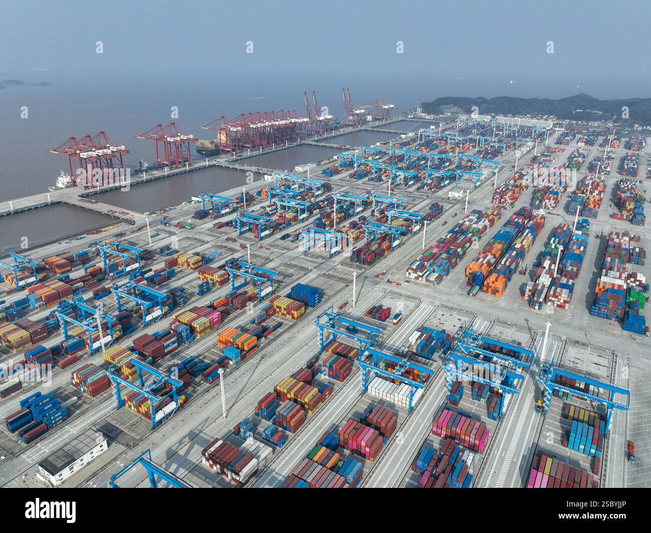 Cargo ships load and unload containers in an orderly manner at the ...