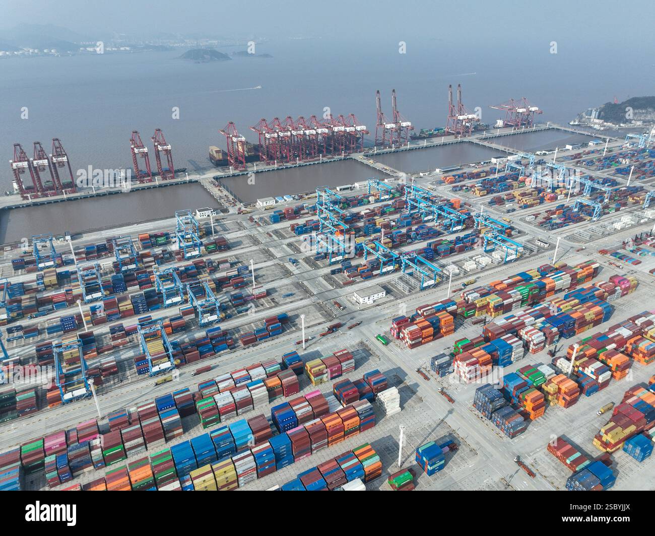 Cargo ships load and unload containers in an orderly manner at the ...