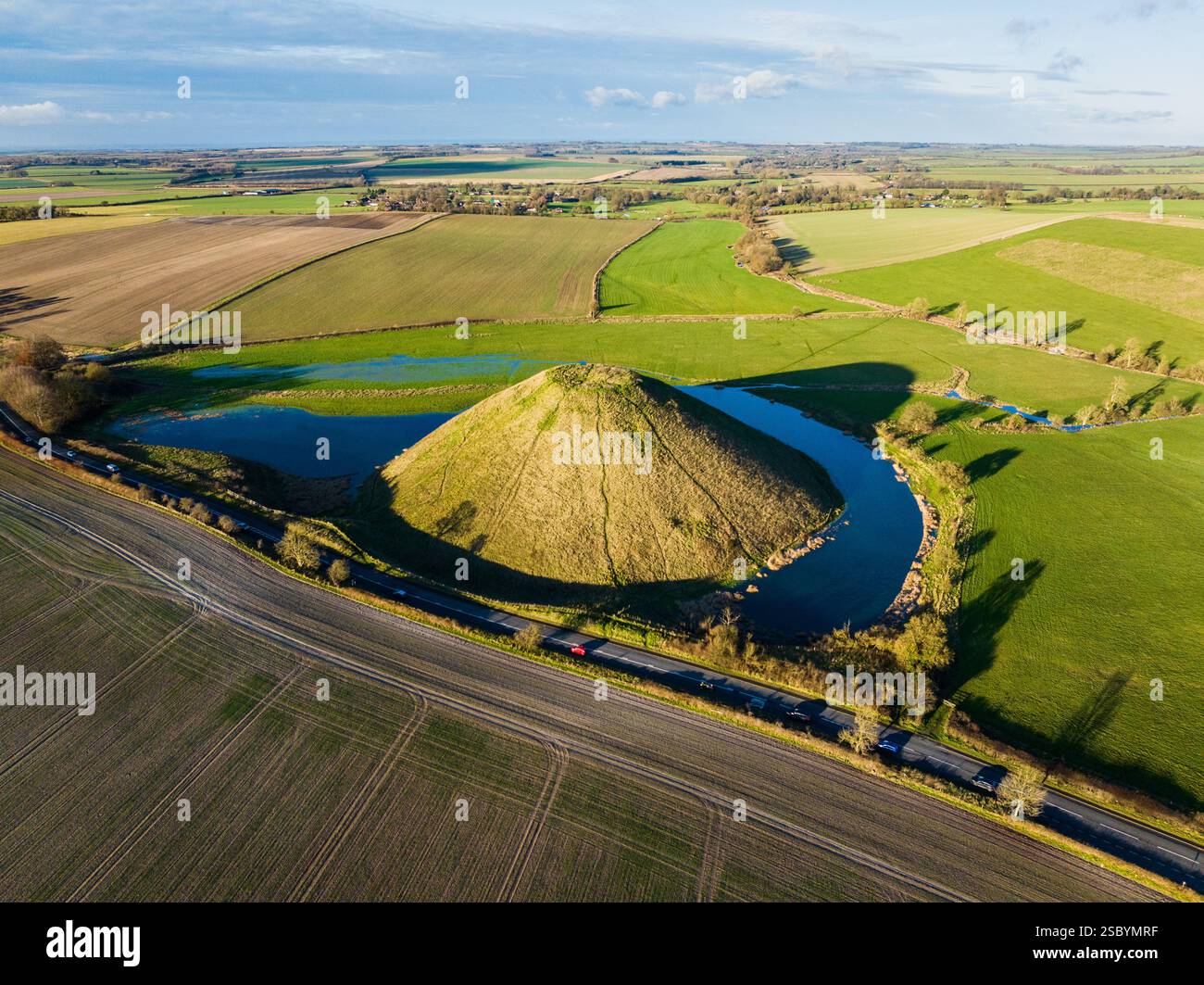 Aerial view of Silbury Hill and surrounding moat in Wiltshire, UK. This ...