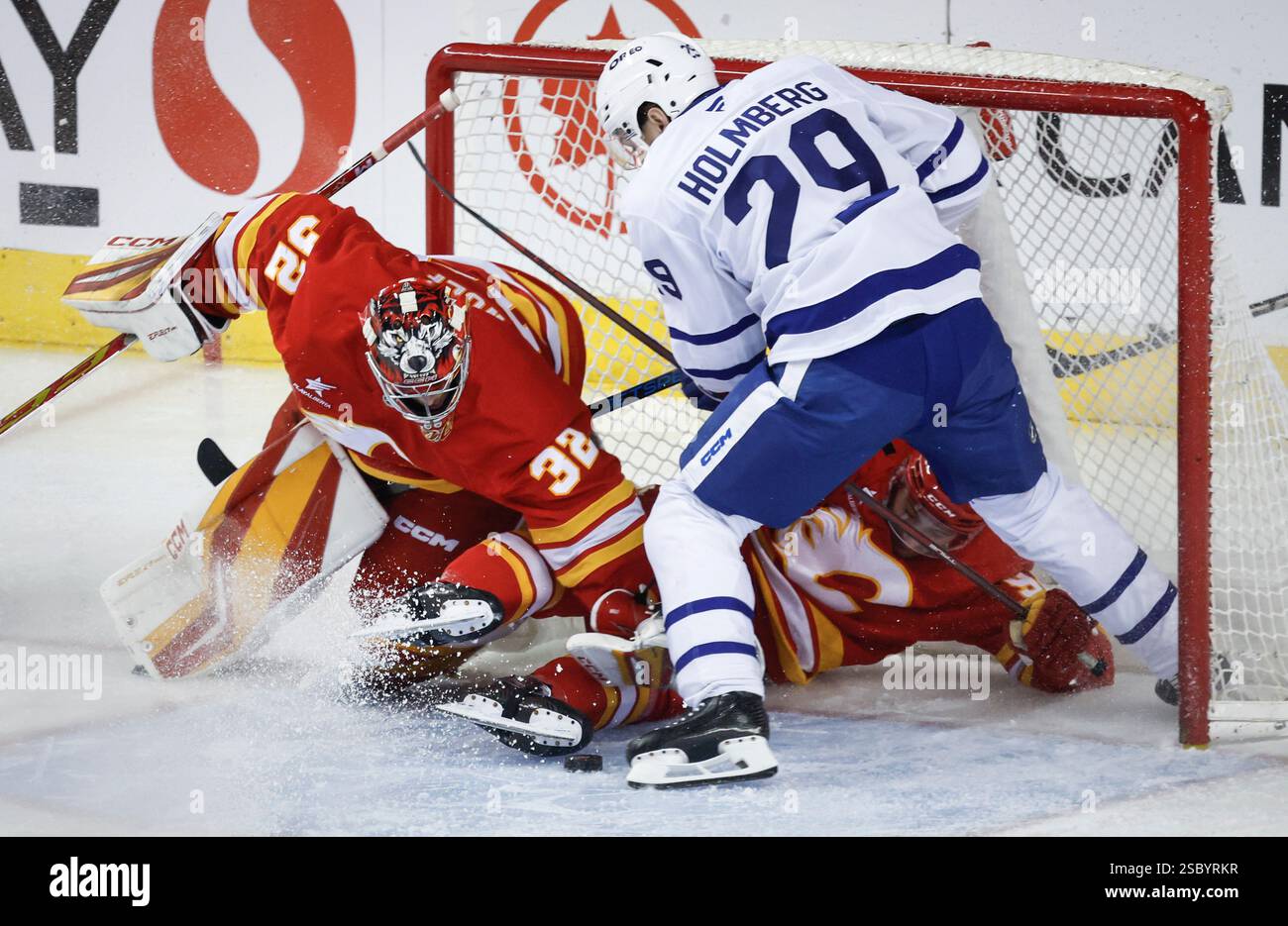 Toronto Maple Leafs' Pontus Holmberg, right, crashes into the net with ...