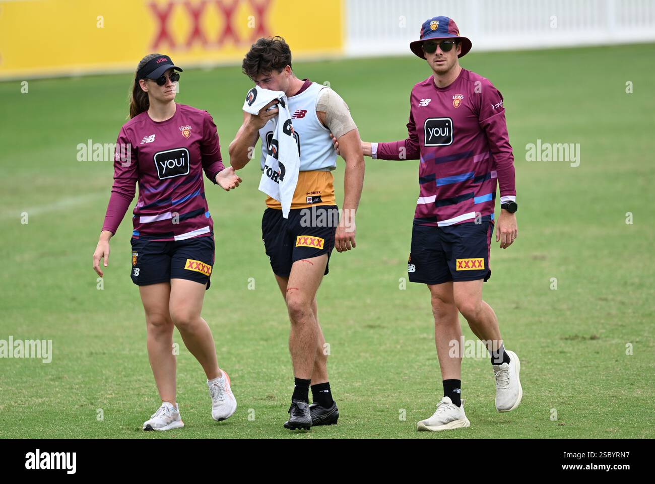Noah Answerth (centre) of the Lions is seen after being injured during ...