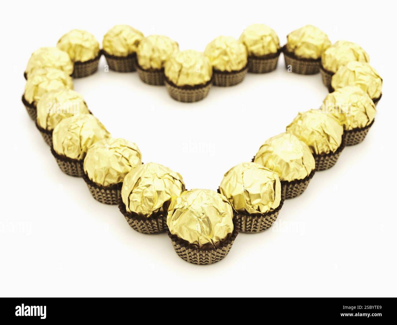 Heart Shape From Sweets In Golden Candy Wrapper Stock Photo - Alamy
