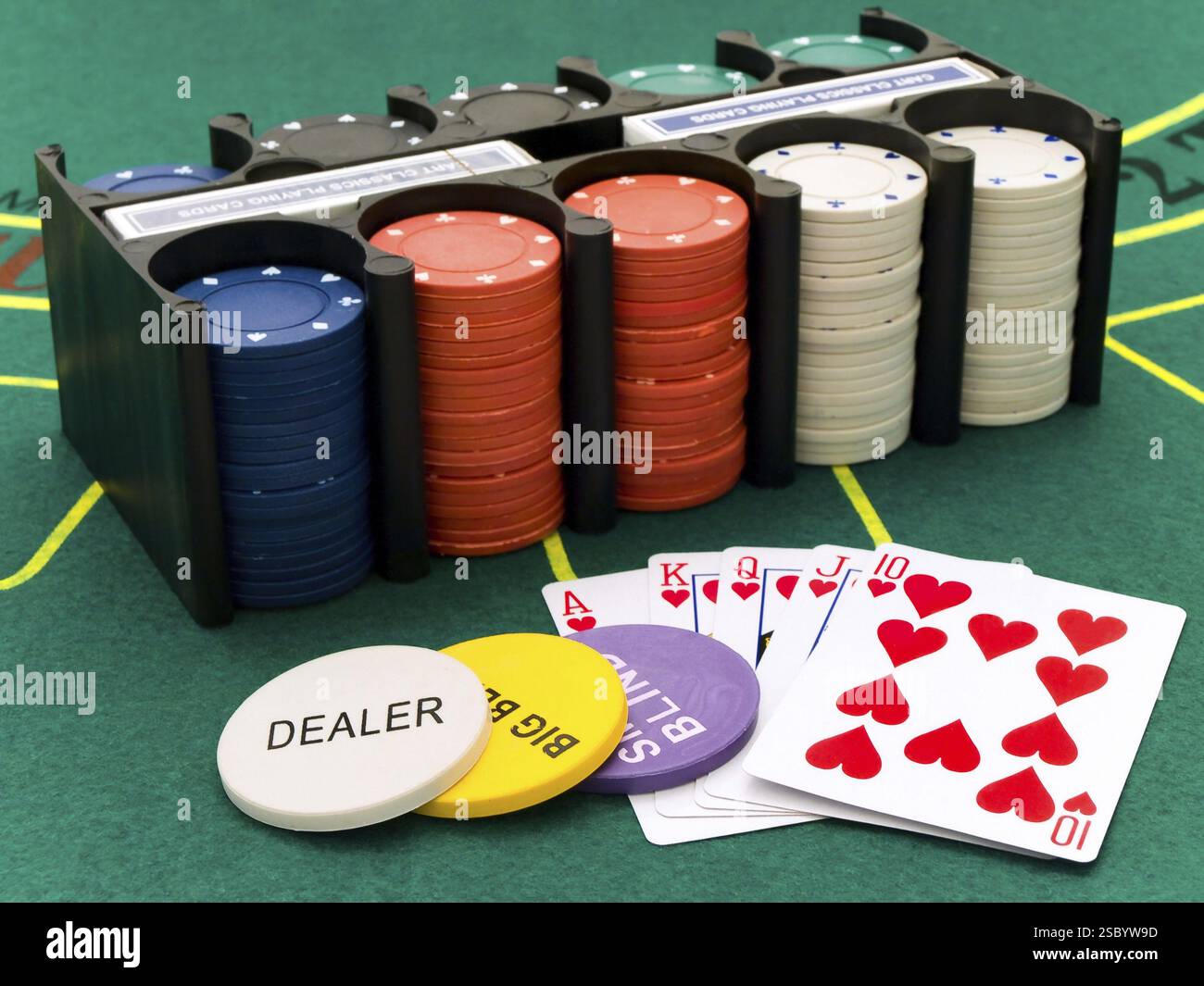 Set of the playing cards and stacks of chips at the green table into ...