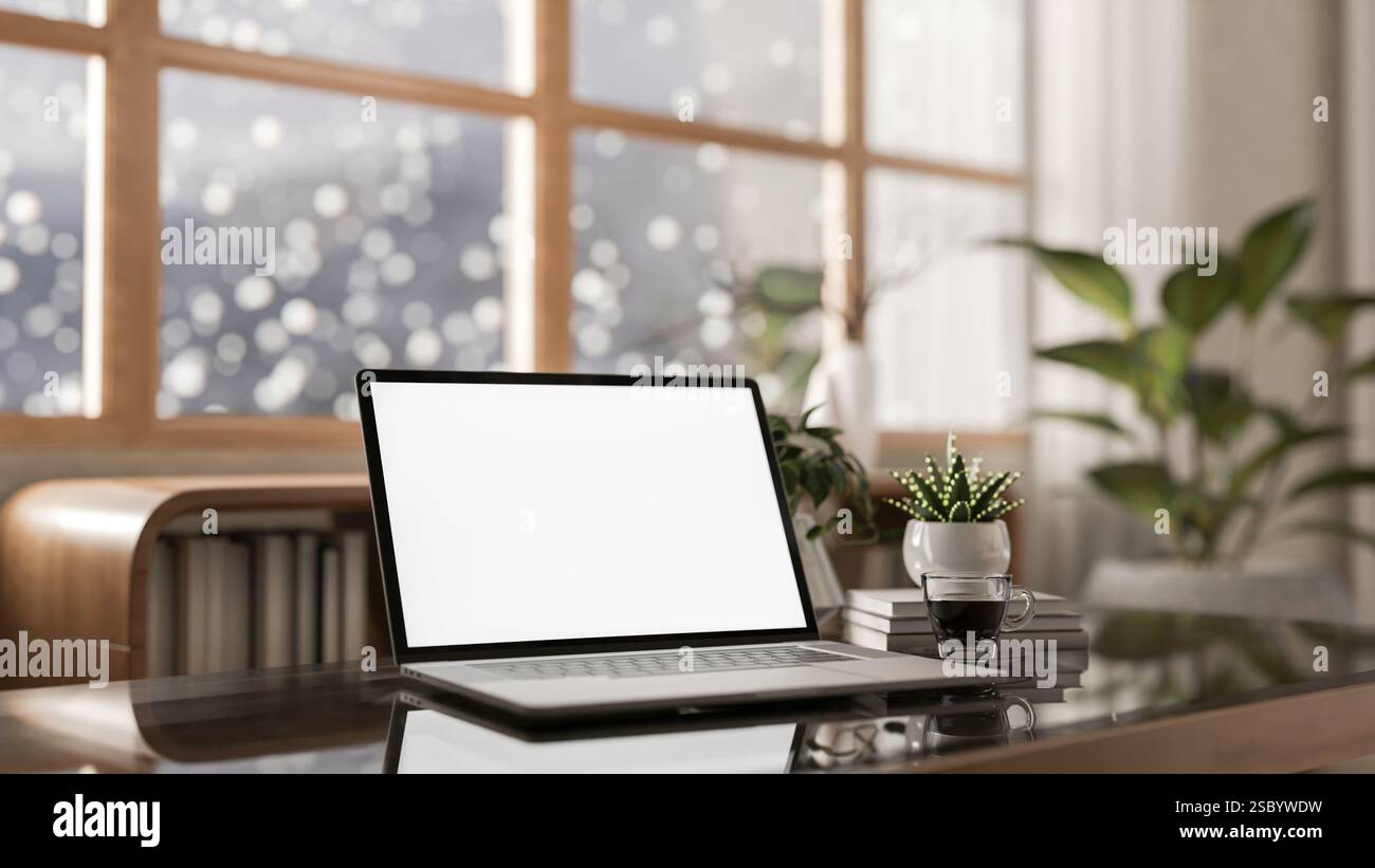 A close-up of a laptop with a white screen mockup placed on a desk in a ...