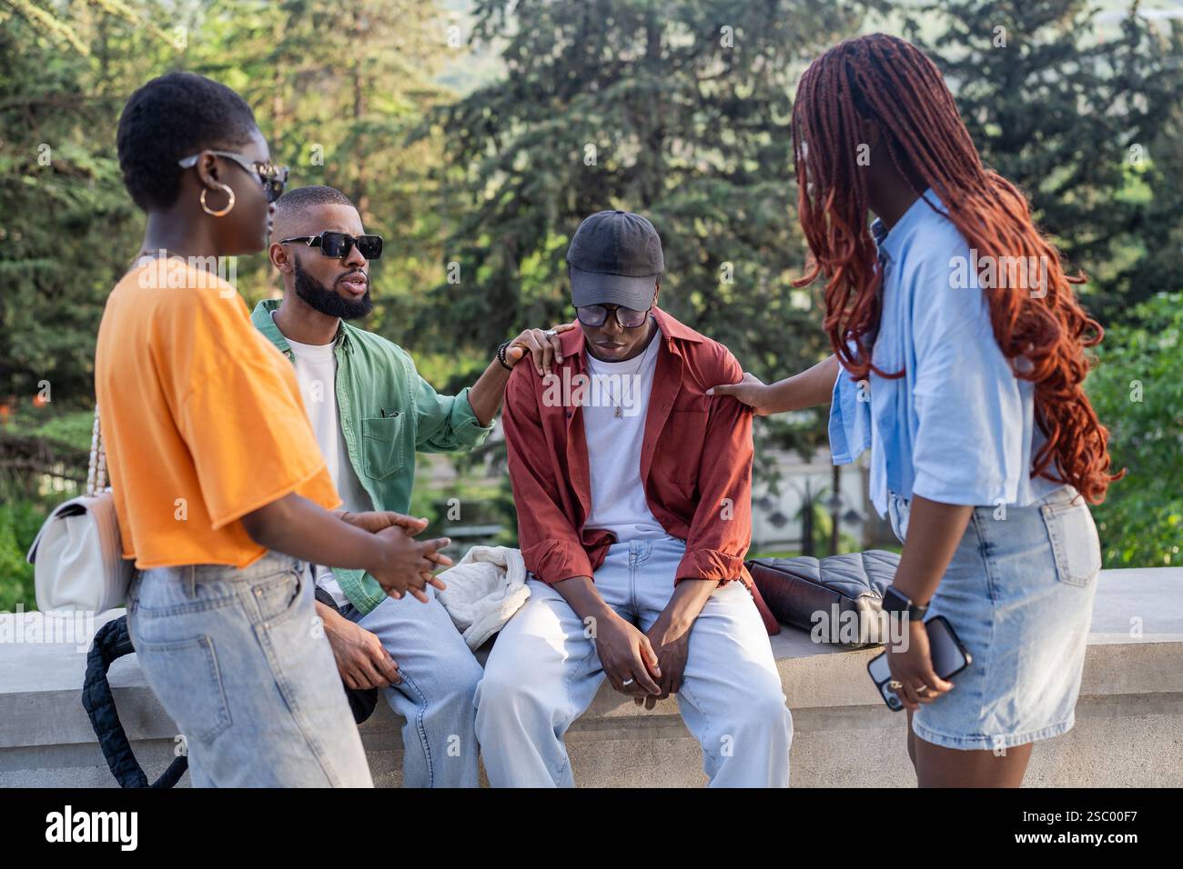 Supportive African American student friends console upset peer after ...