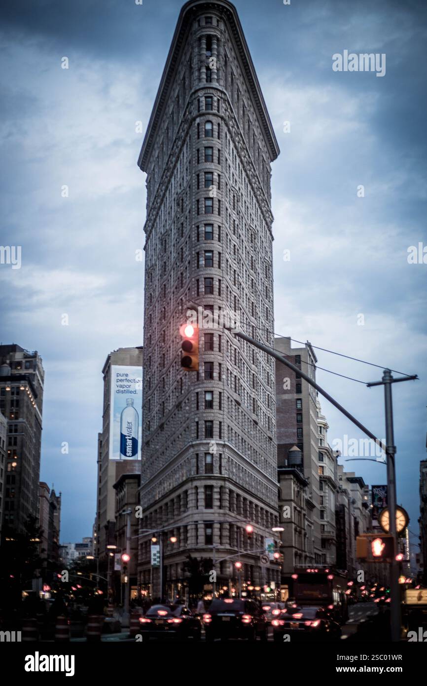 Historic Flatiron Building towers among urban streets at dusk Stock ...