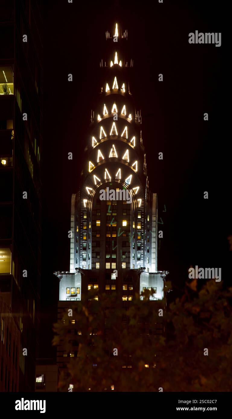 The Chrysler building iconic tower skyscraper at night in Midtown ...
