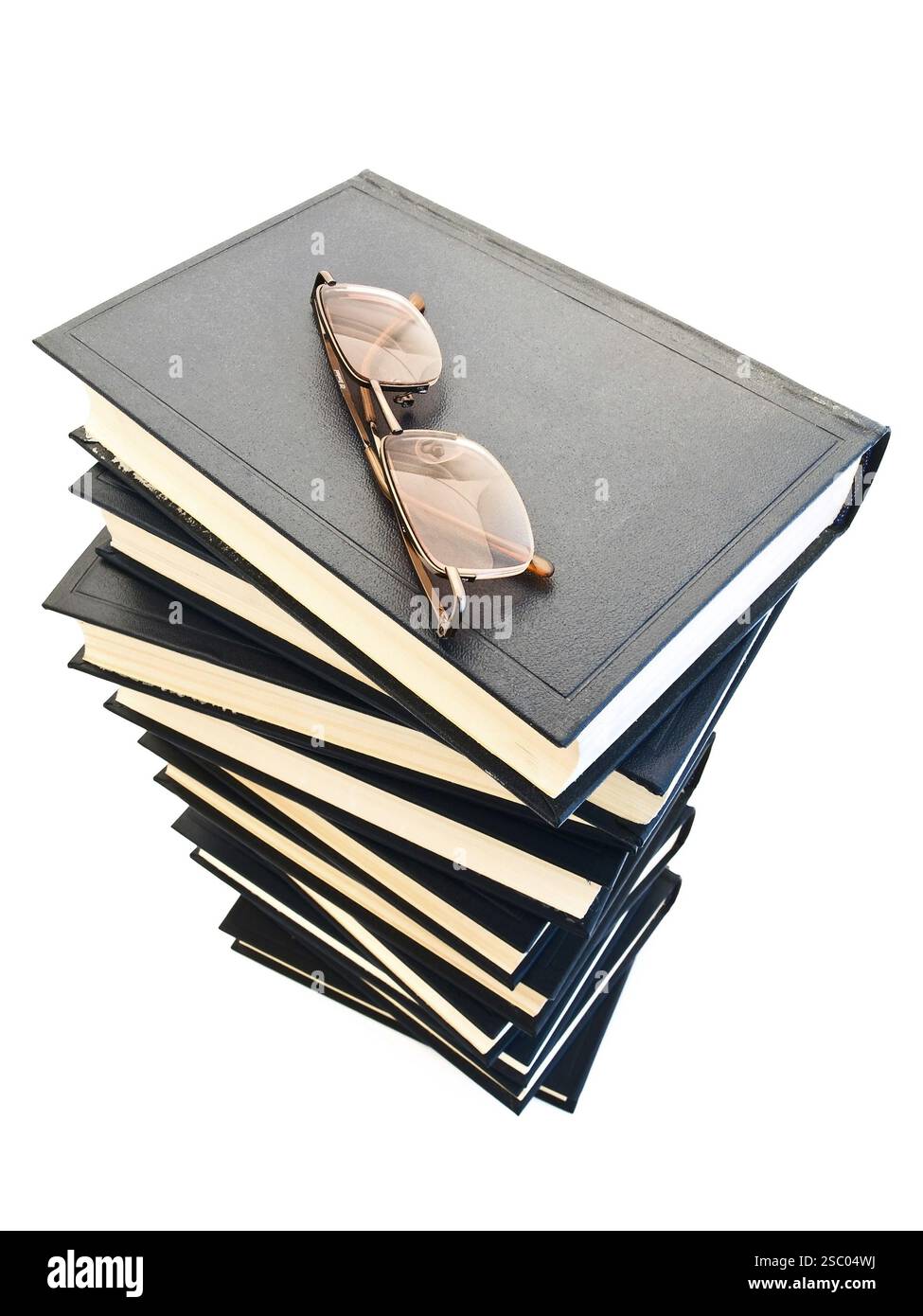 Glasses at the top of the blue books pile Stock Photo - Alamy