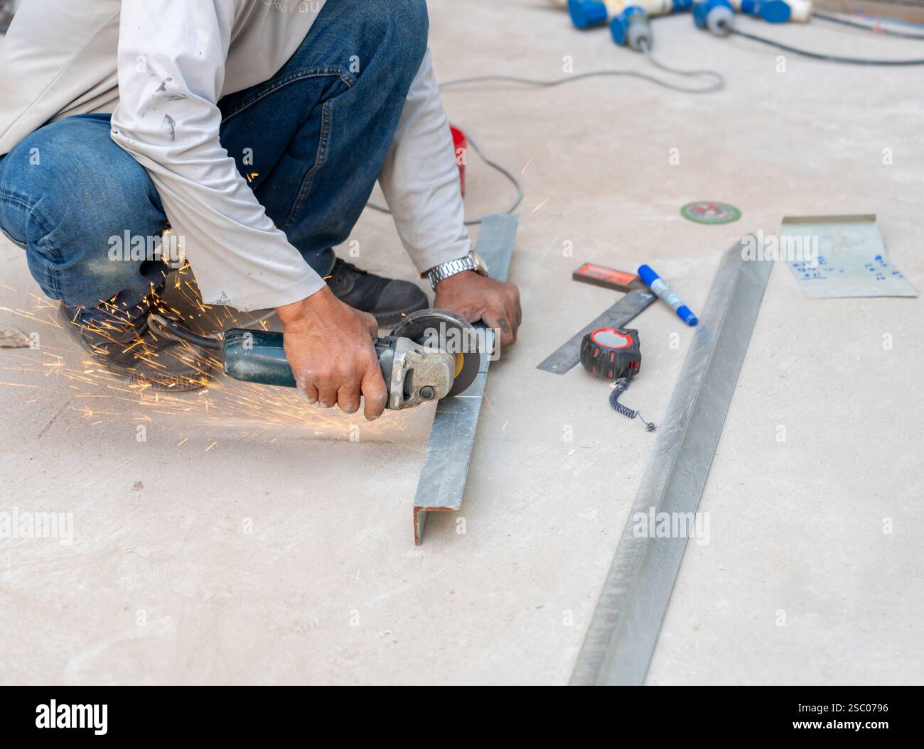 Construction worker using electrical angle grinder for cutting angle ...
