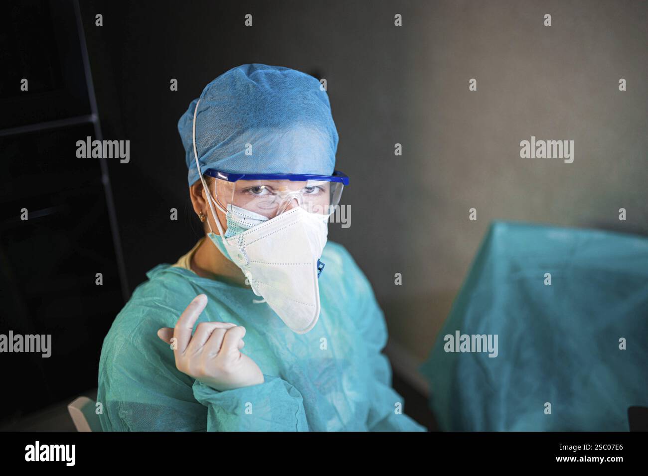 A healthcare worker in PPE making a hand gesture Stock Photo - Alamy
