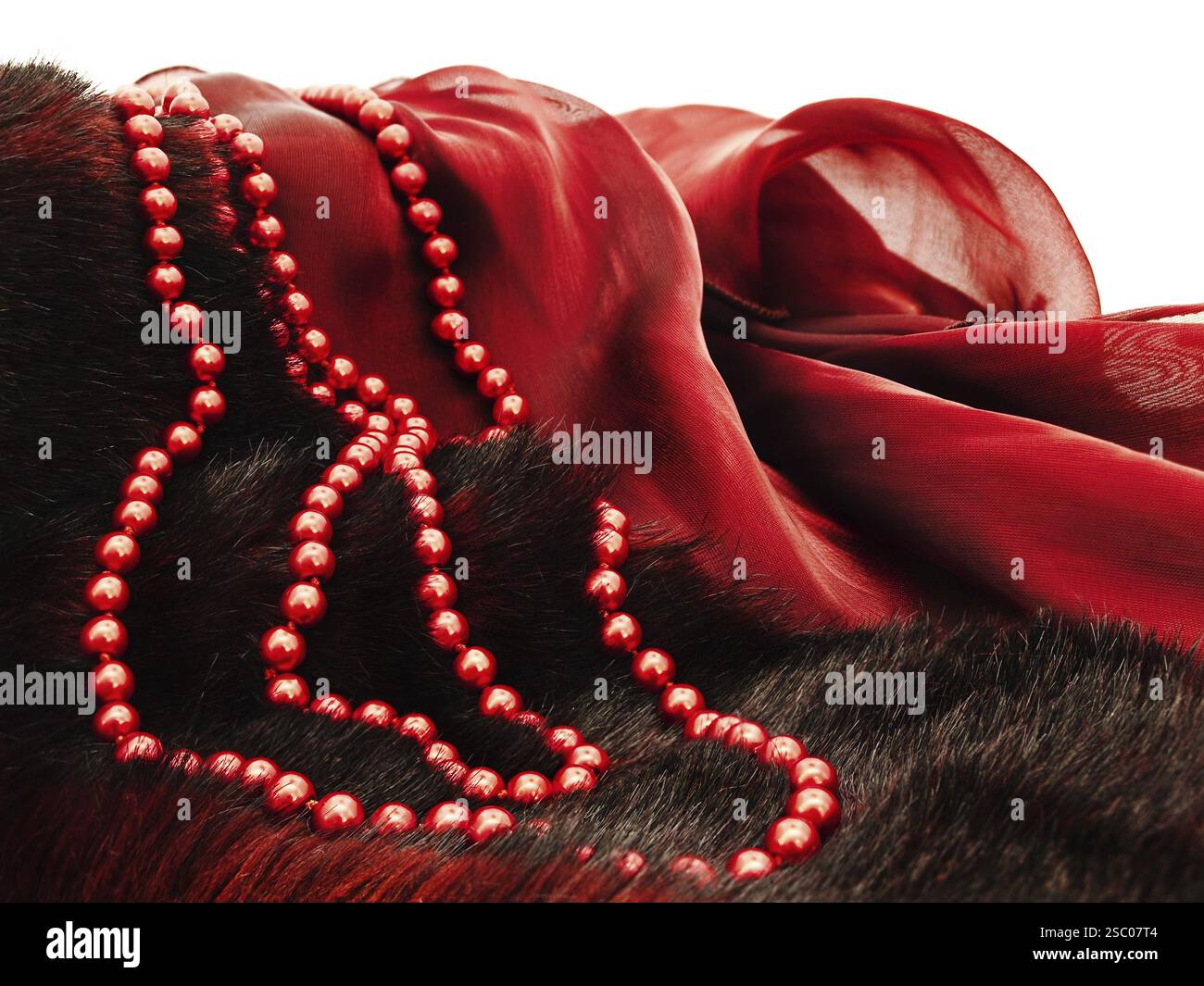 Fashion red necklace in chaplet shape over burgundy textile and fur ...