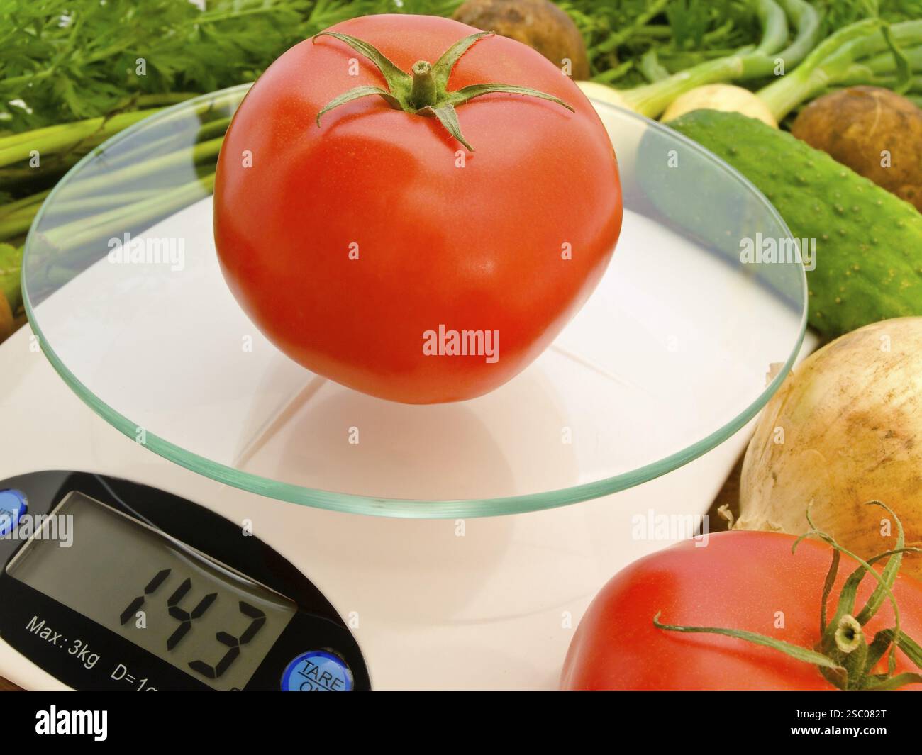 Fresh tomato on the scales that show the weight in grams Stock Photo ...
