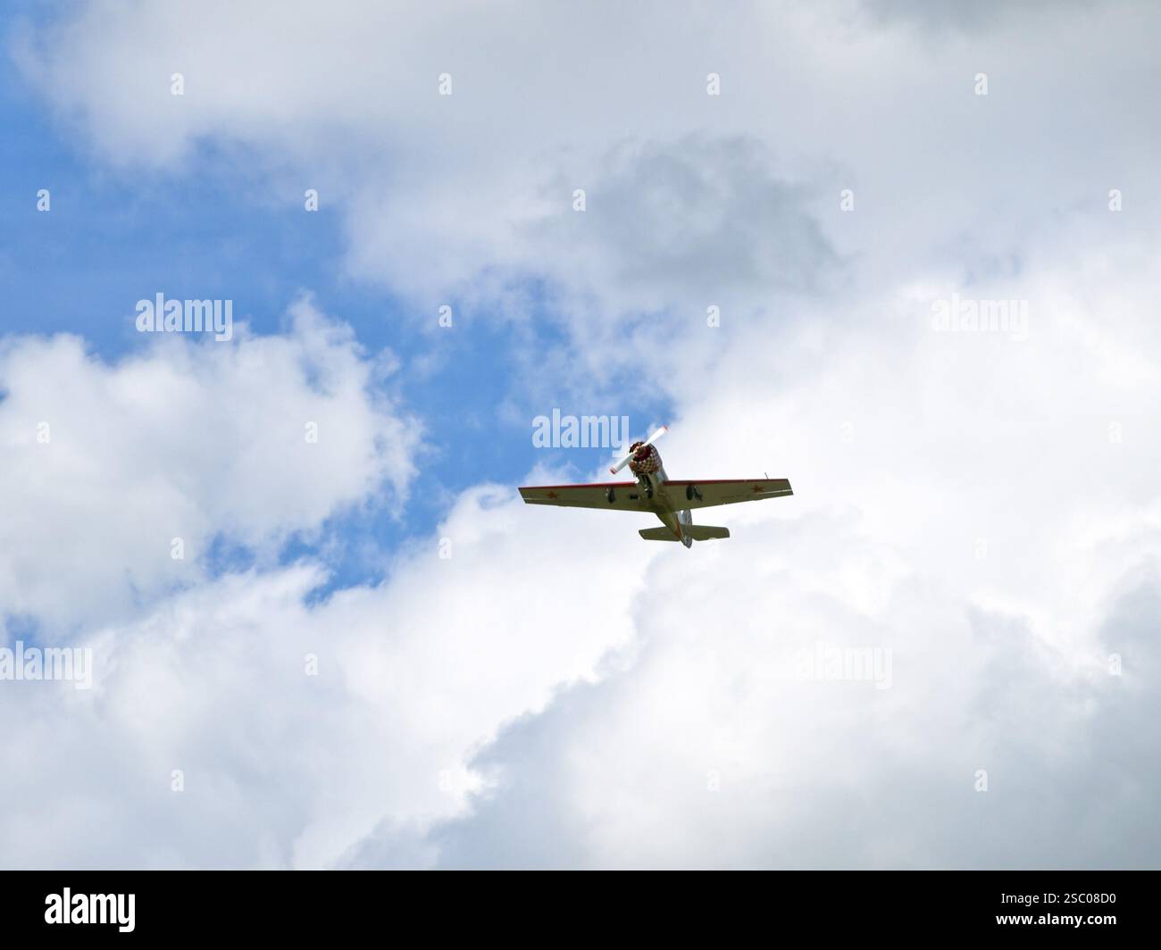 Tiny plane flying through cloudy hi-res stock photography and images ...