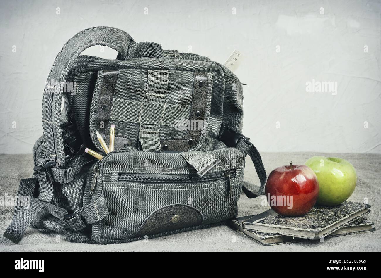 Still Life With An Old Backpack, Books And Apples Stock Photo - Alamy
