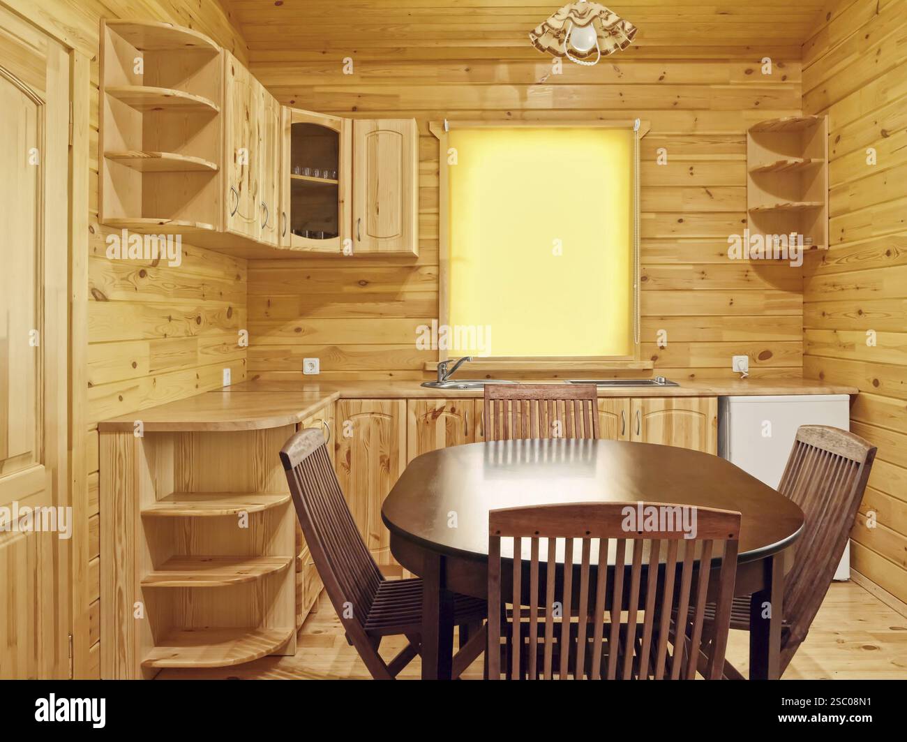 Interior of the kitchen in a wooden blockhouse Stock Photo - Alamy