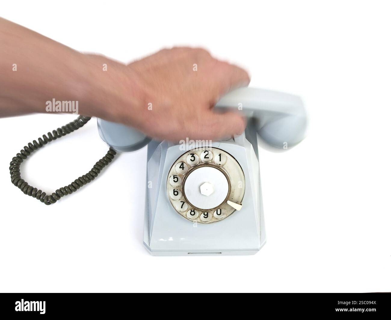 Man hand putting the handset of the old blue phone against the white ...