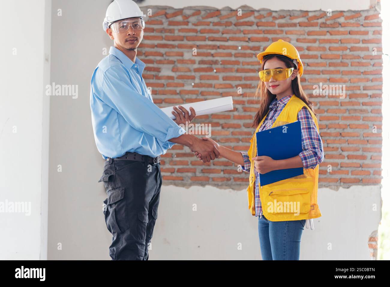 Civil Construction engineer teams shaking hands together wear work ...