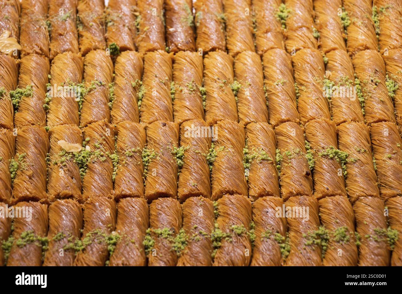 Turkish traditional dessert Kadayif baked in syrup served with nut ...