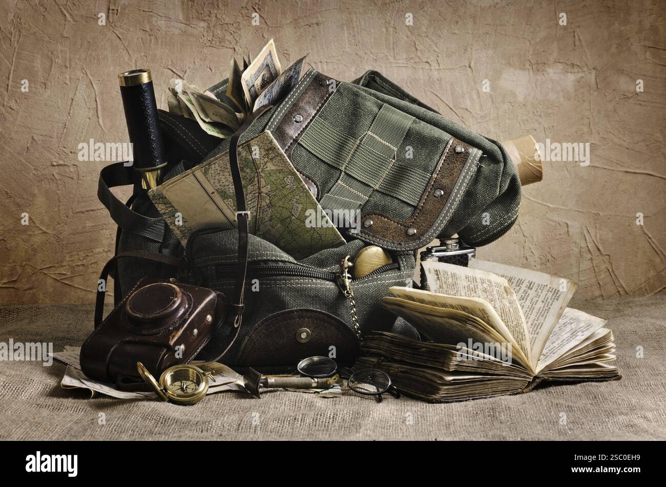 Still life with an old backpack and travel accessories Stock Photo - Alamy