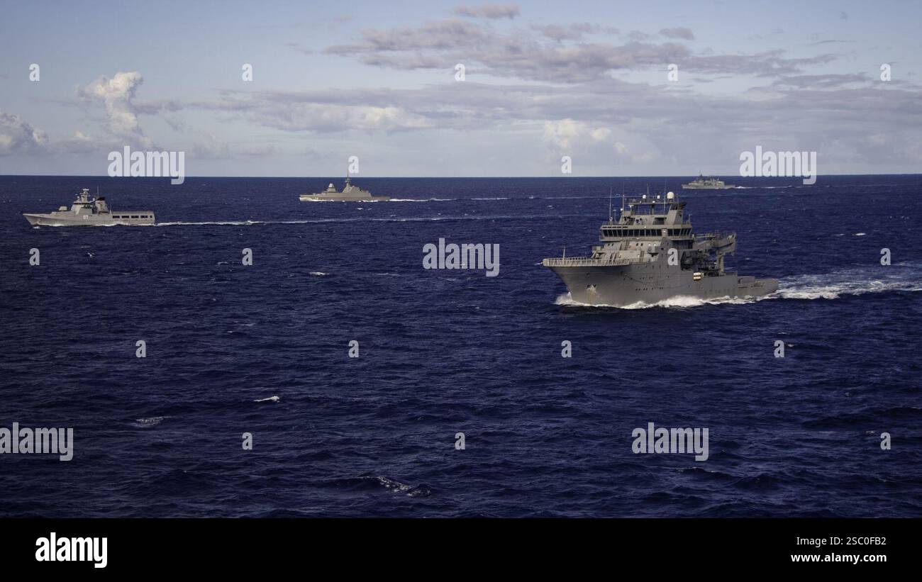 HMNZS Manawanui (A09) maneuver in formation with other navy ships of ...