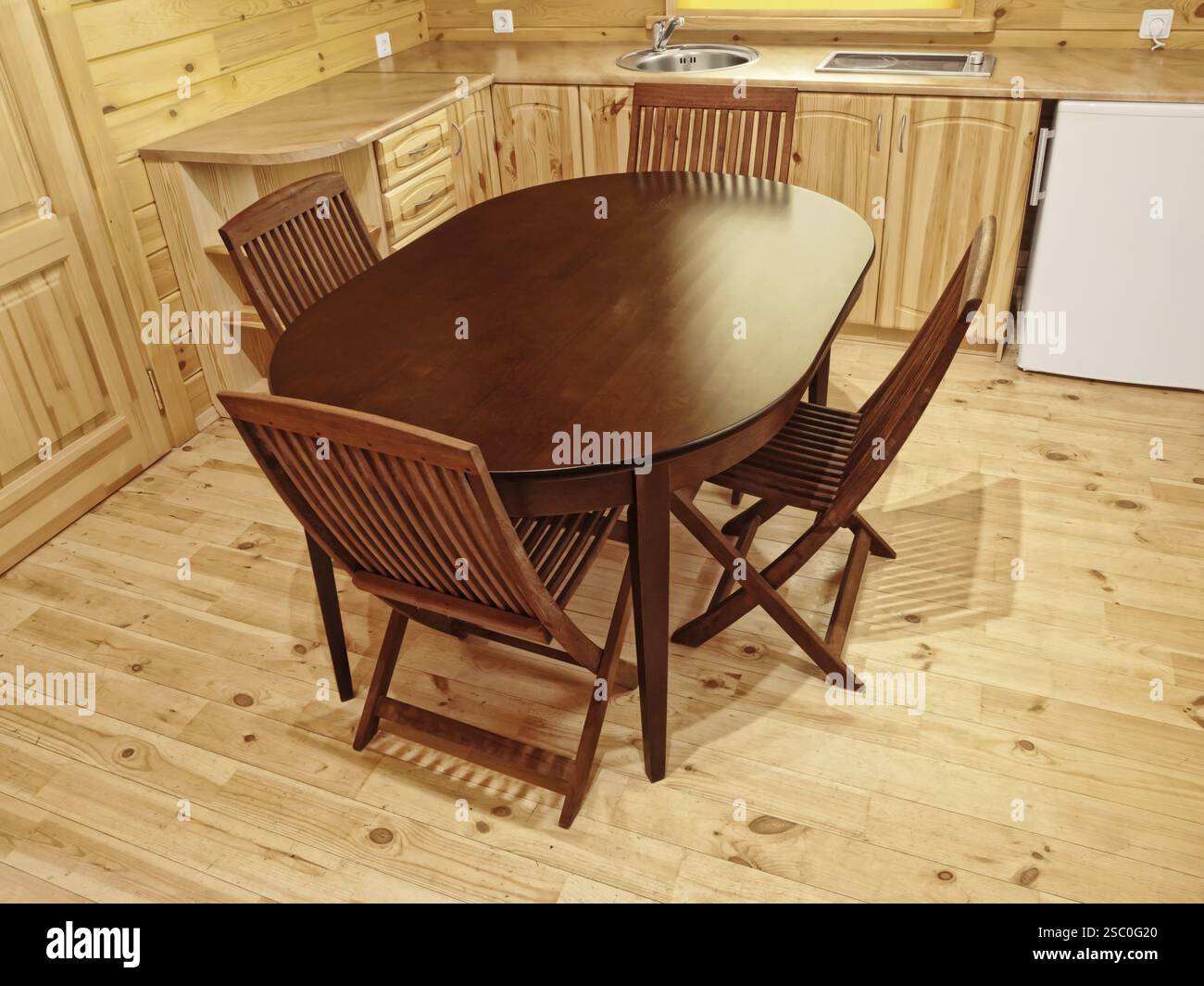 Interior of the kitchen in a wooden blockhouse Stock Photo - Alamy