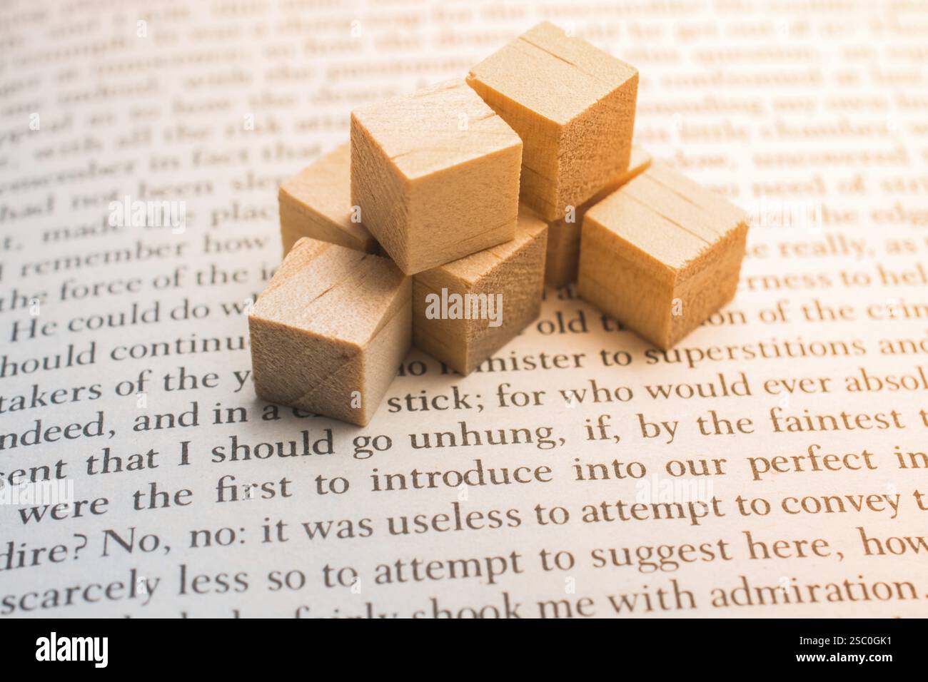 Wooden toy cubes placed on a book page in English Stock Photo - Alamy