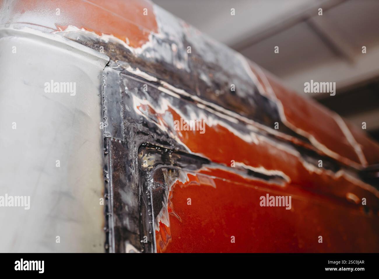 Detail of rust repair on a car with exposed metalwork Stock Photo - Alamy