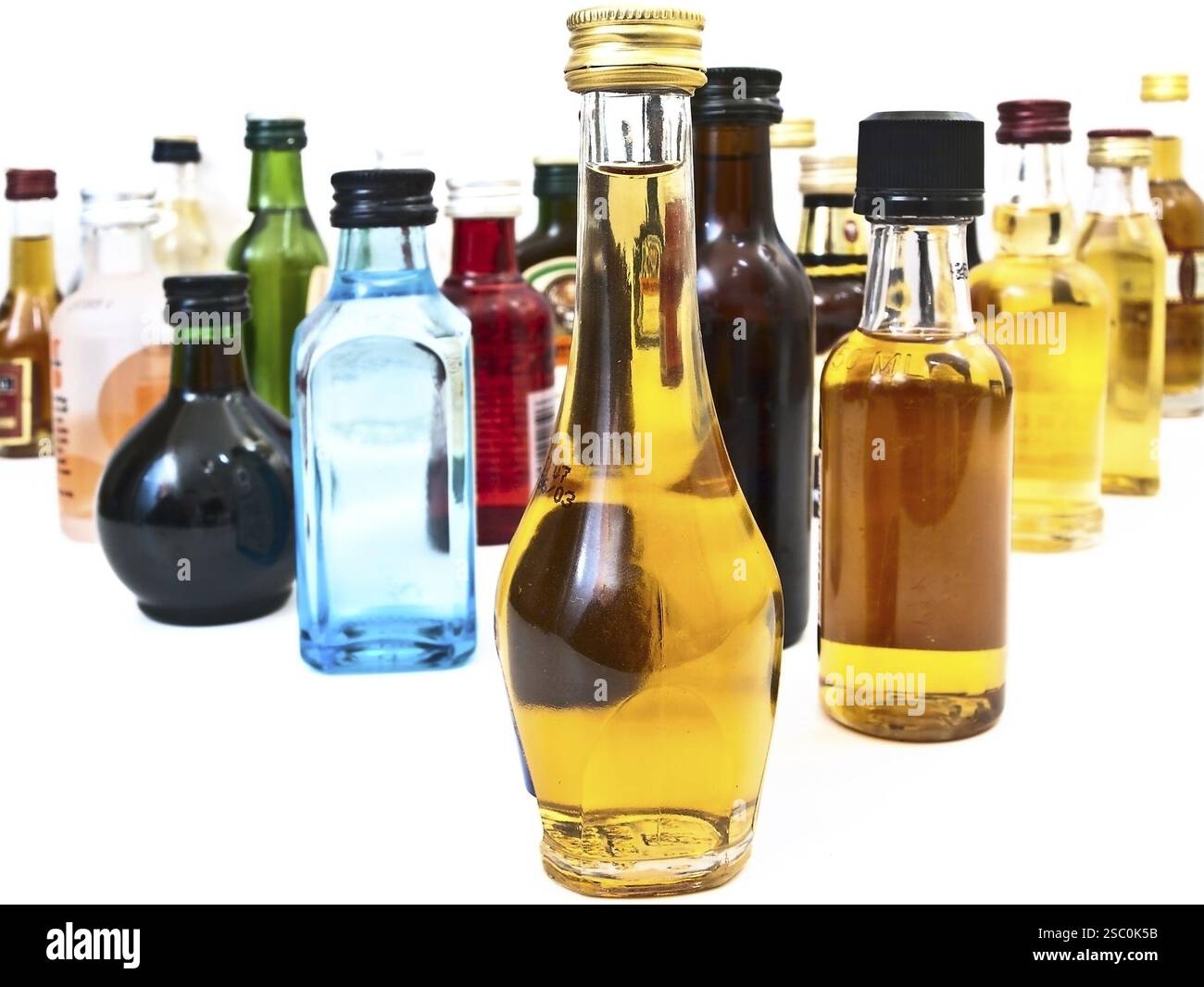 Different alcohol bottles against the white background Stock Photo - Alamy