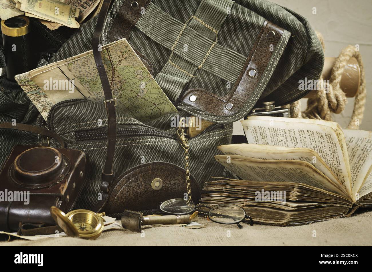 Still life with an old backpack and travel accessories Stock Photo - Alamy