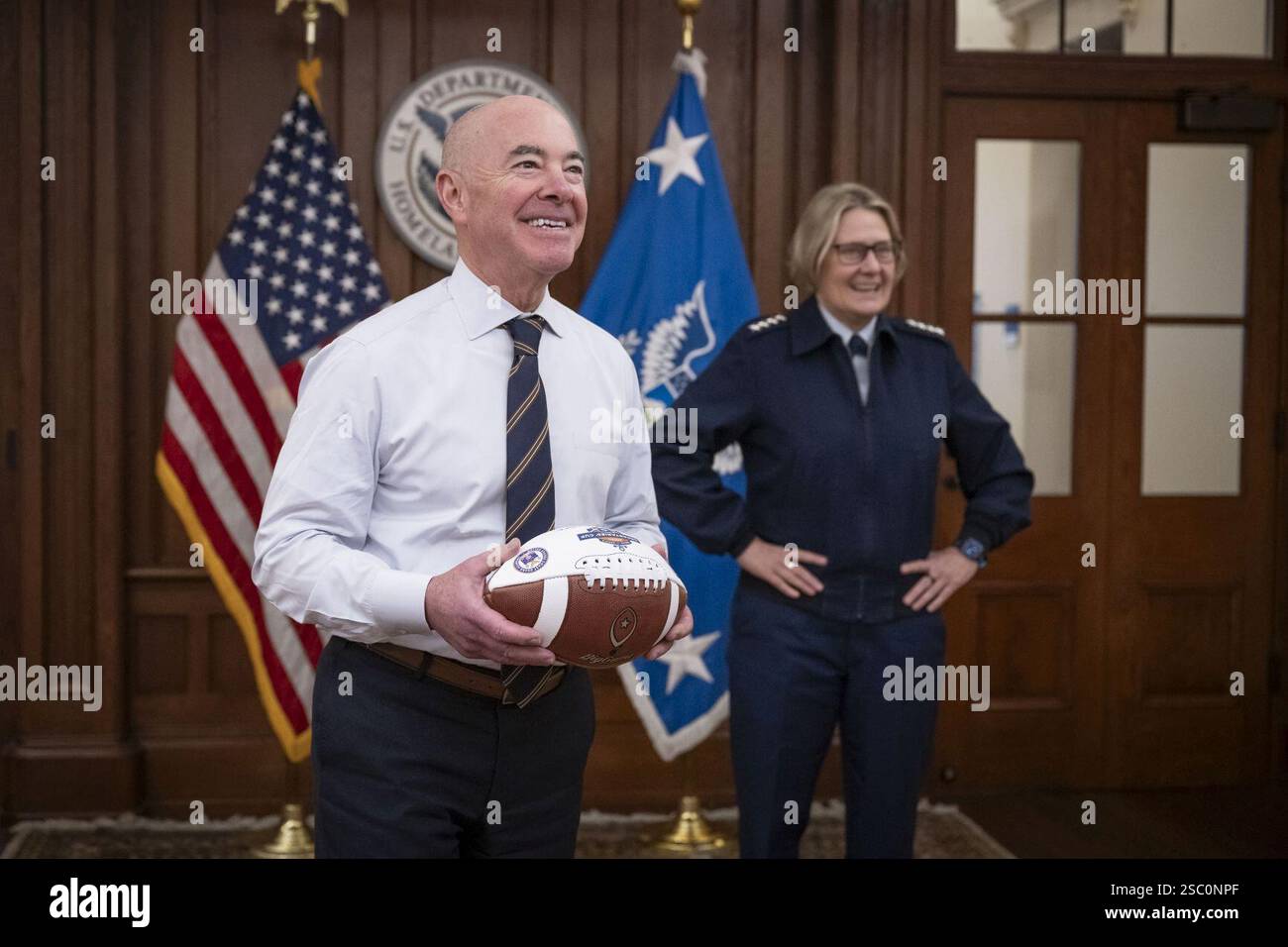 Homeland Security Secretary Alejandro Mayorkas is presented with the ...
