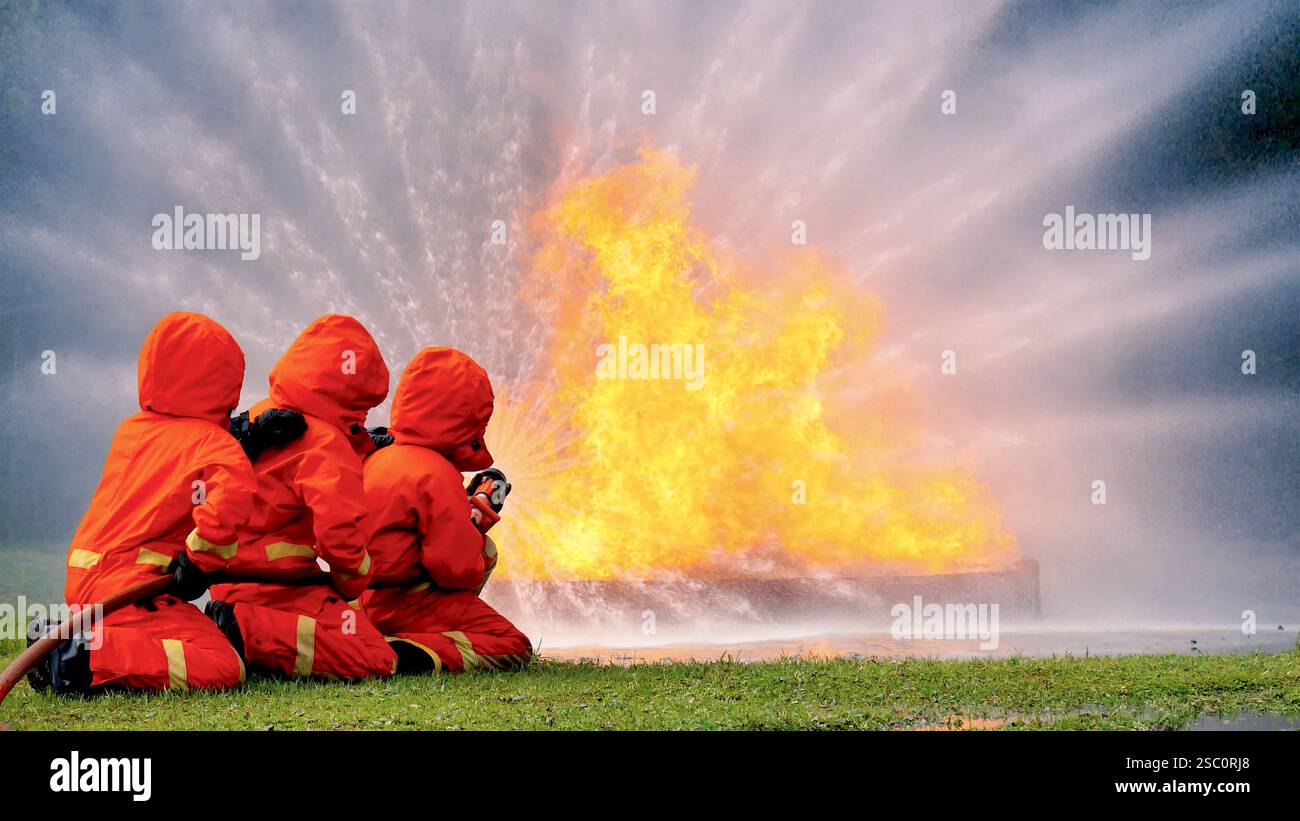 Firefighter fighting with flame using fire hose chemical water foam ...