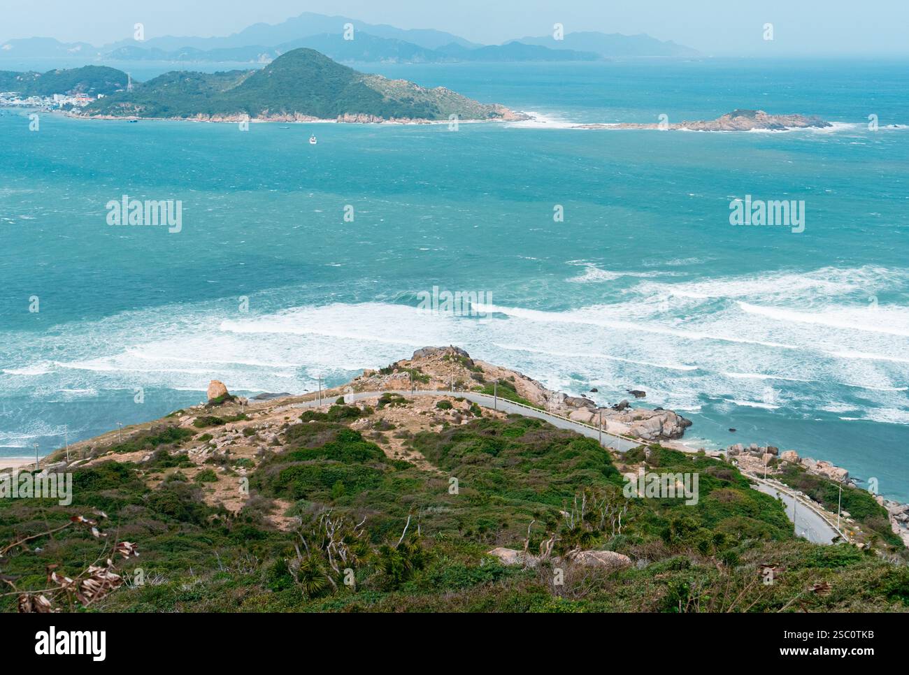 Scenic coastal road at Ninh Thuan, Viet Nam with Binh Hung Island in the distance - Vinh Hy bay ...