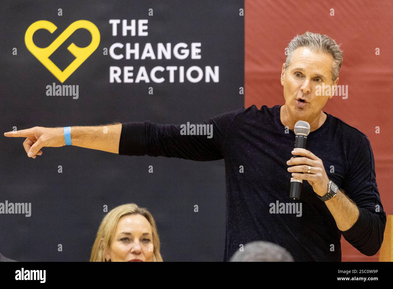 The Change Reaction founder Greg Perlman delivers a speech as he ...