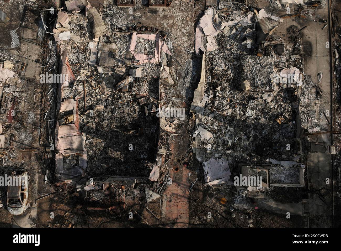 An aerial photo shows the charred homes of Louise Hamlin, right, and ...