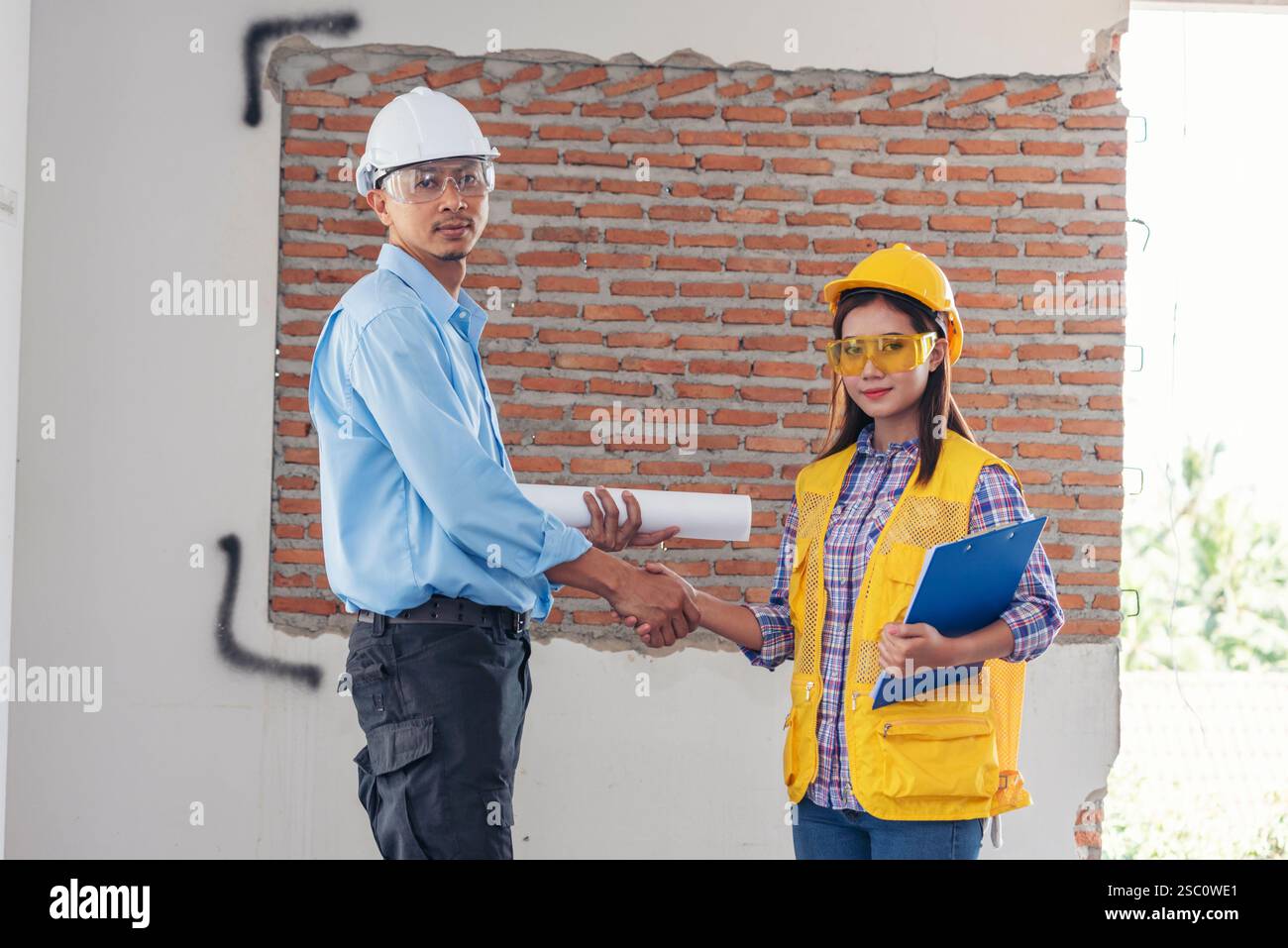 Civil Construction engineer teams shaking hands together wear work ...