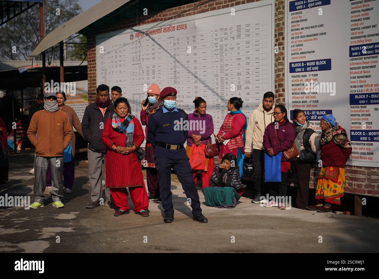 Members of the public wait outside the maternity wing of Bhaktapur ...