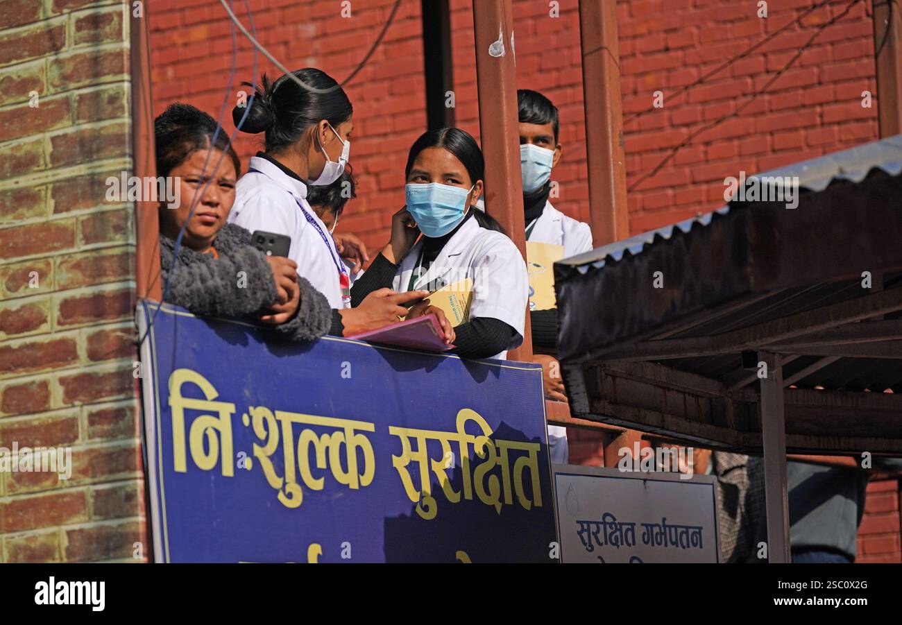 Members of staff wait outside the maternity wing of Bhaktapur Hospital ...