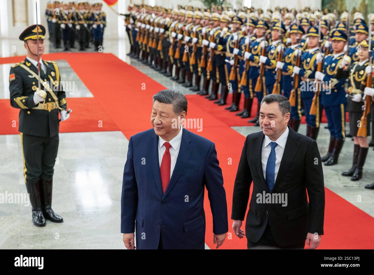 Chinese President Xi Jinping, center, walks with Kyrgyzstan's President ...