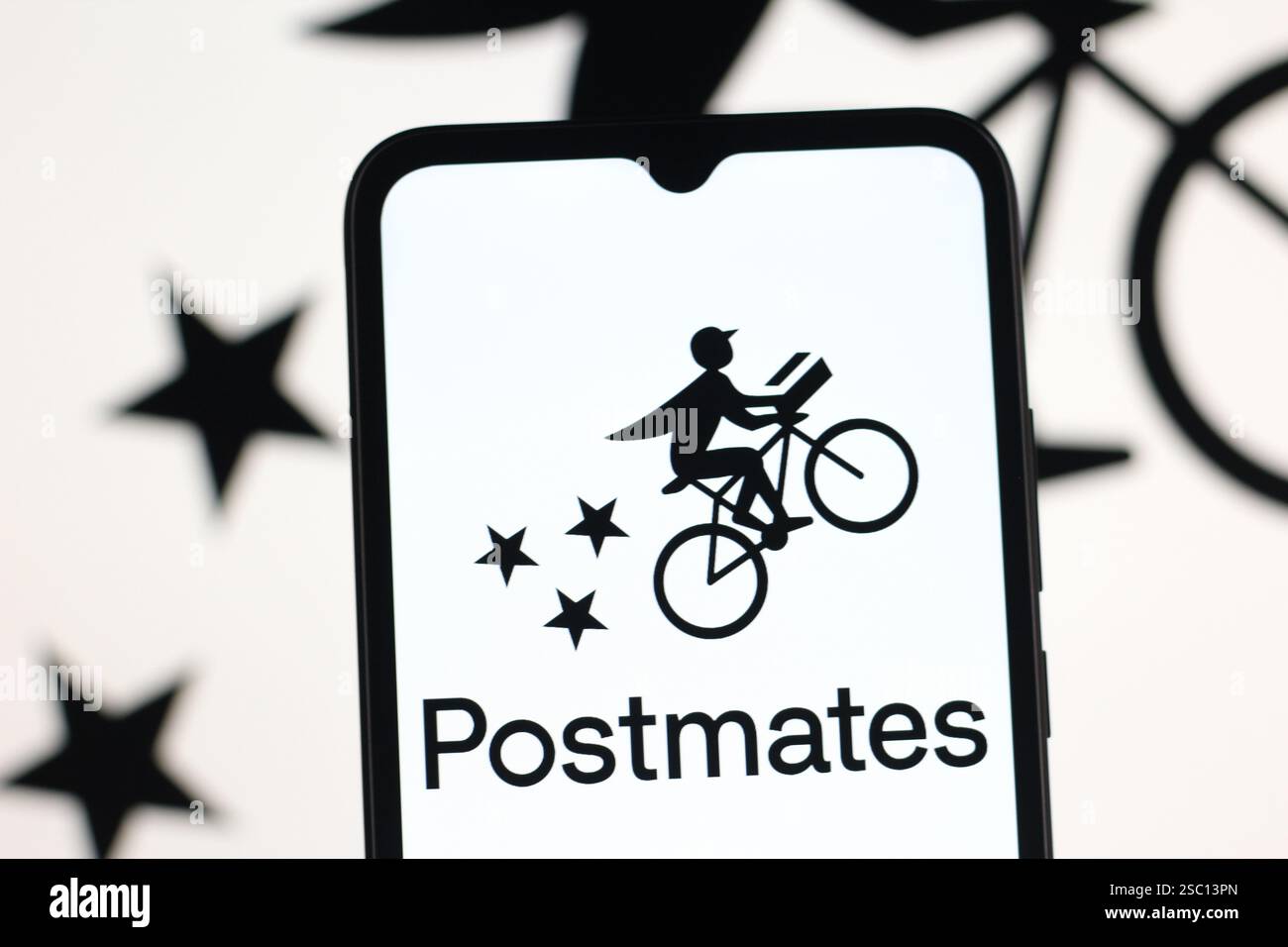 In this photo illustration, the Postmates logo is seen displayed on a ...