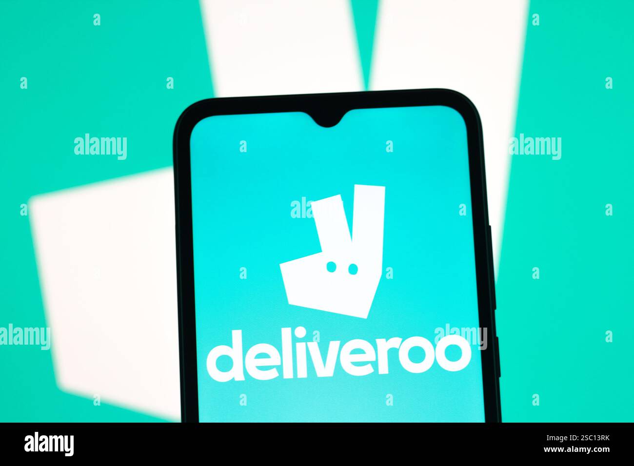 In this photo illustration, the Deliveroo logo is seen displayed on a ...