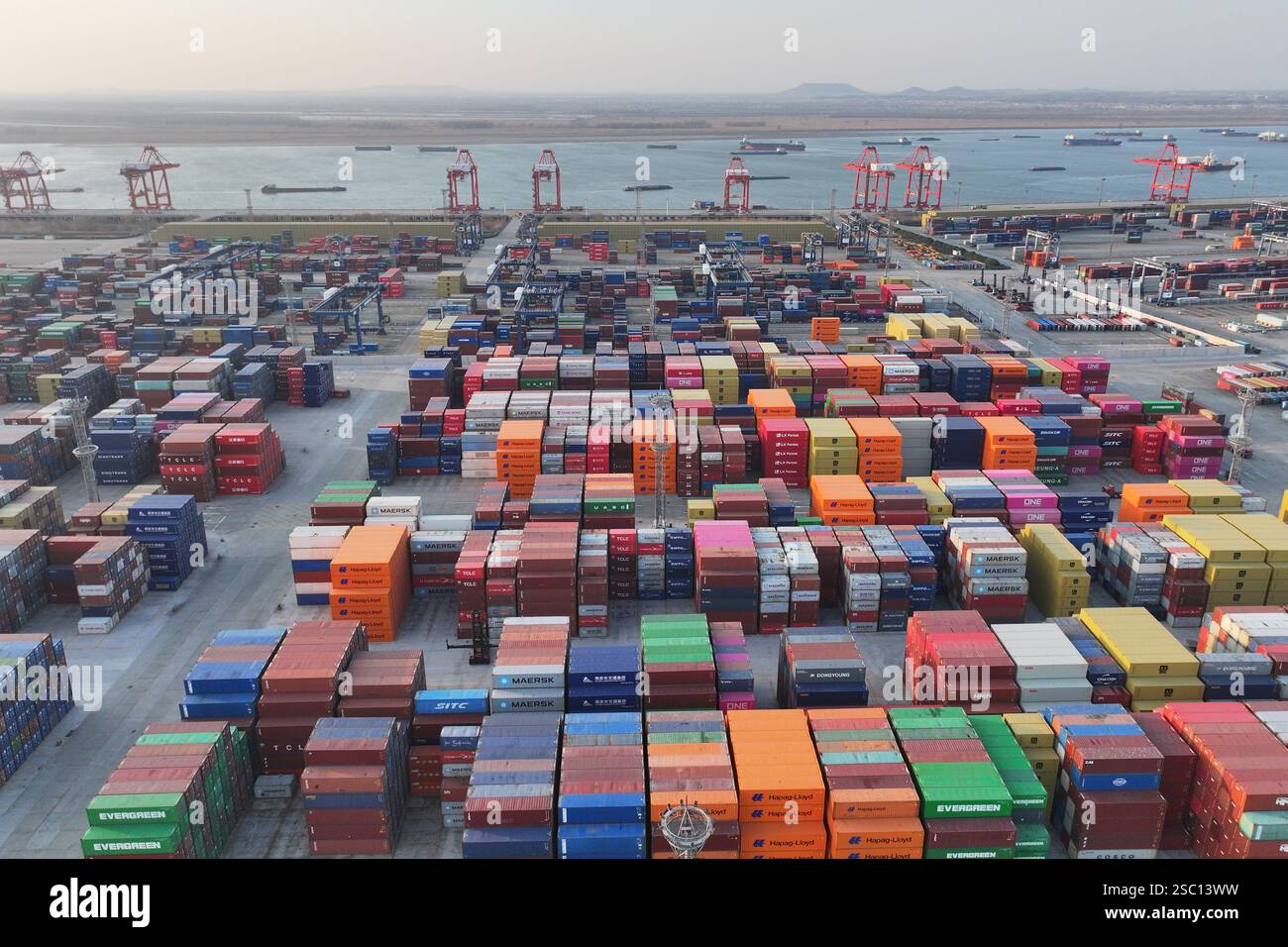 Trucks carry containers at a yard at the Nanjing Port Longtan Container ...